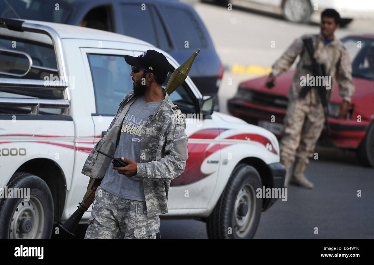 Militiamen have set up a checkpoint on a road to the airport and check ...