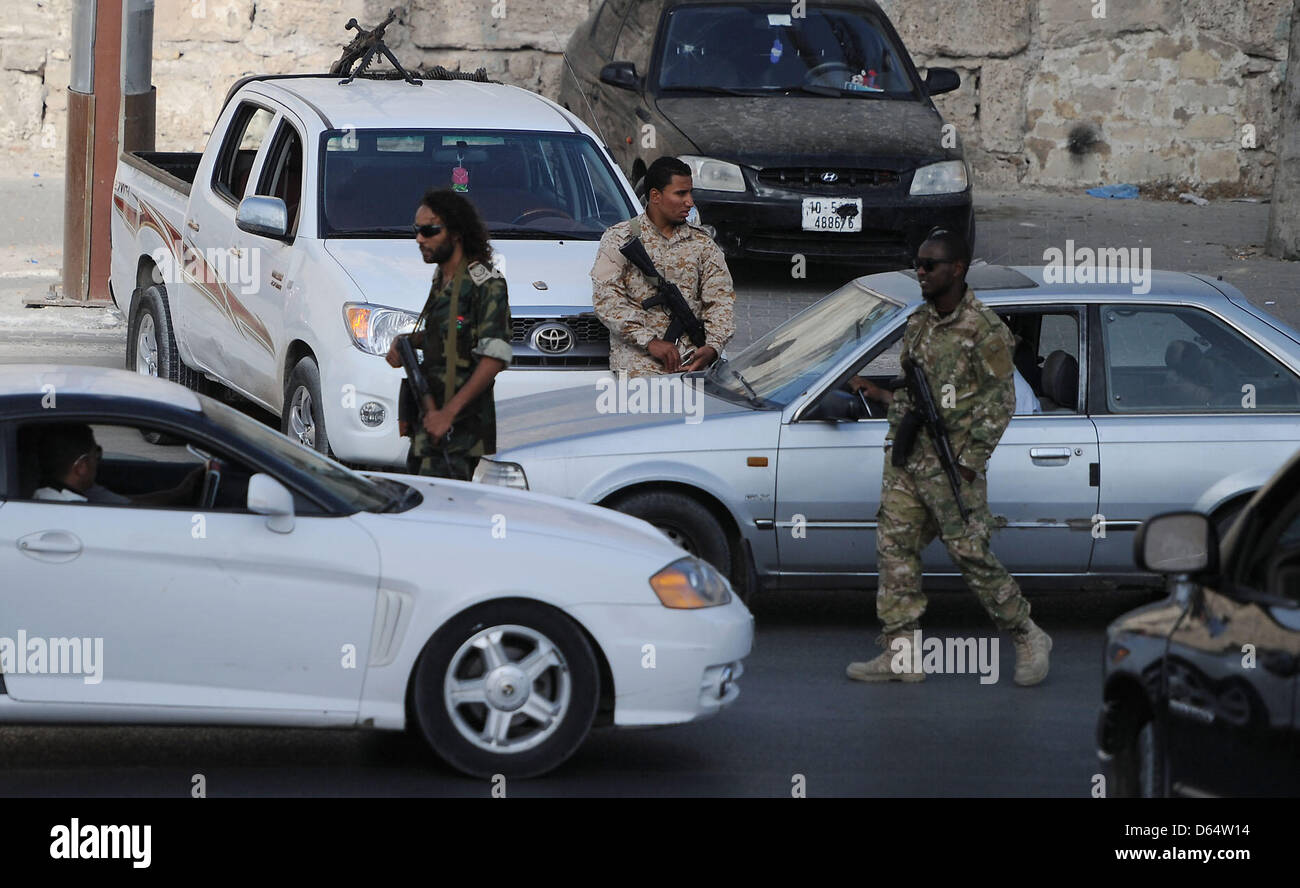 Militiamen have set up a checkpoint on a road to the airport and check ...