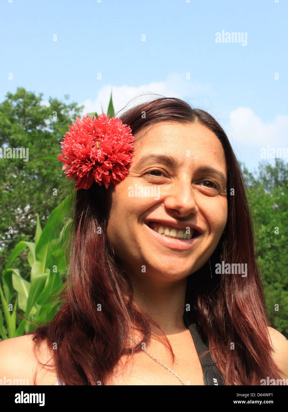 A woman and girl with poppy flowers in their hair, captured in a moment ...