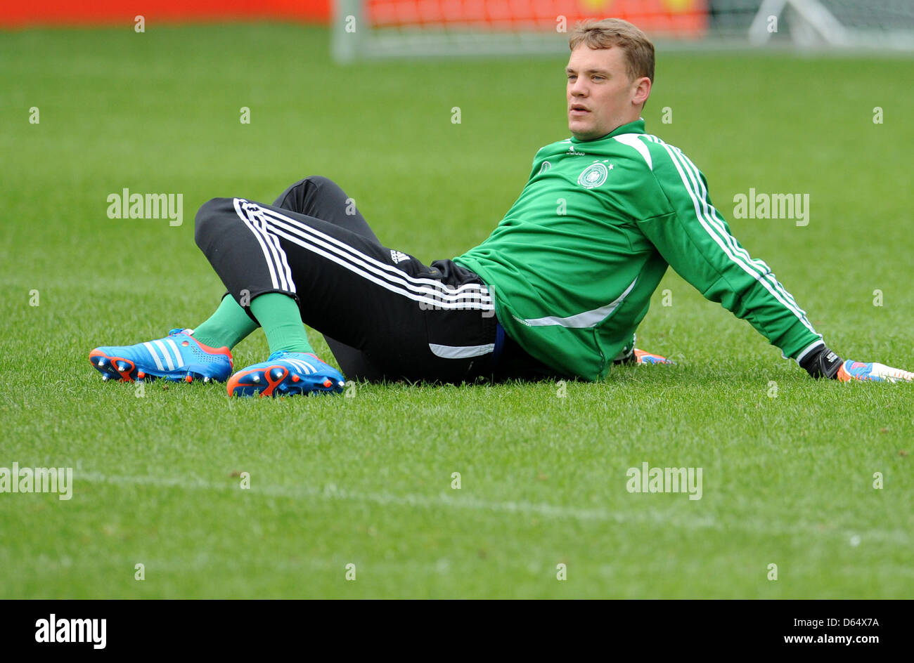Germany's goalkeeper Manuel Neuer sits on the pitch during a training ...