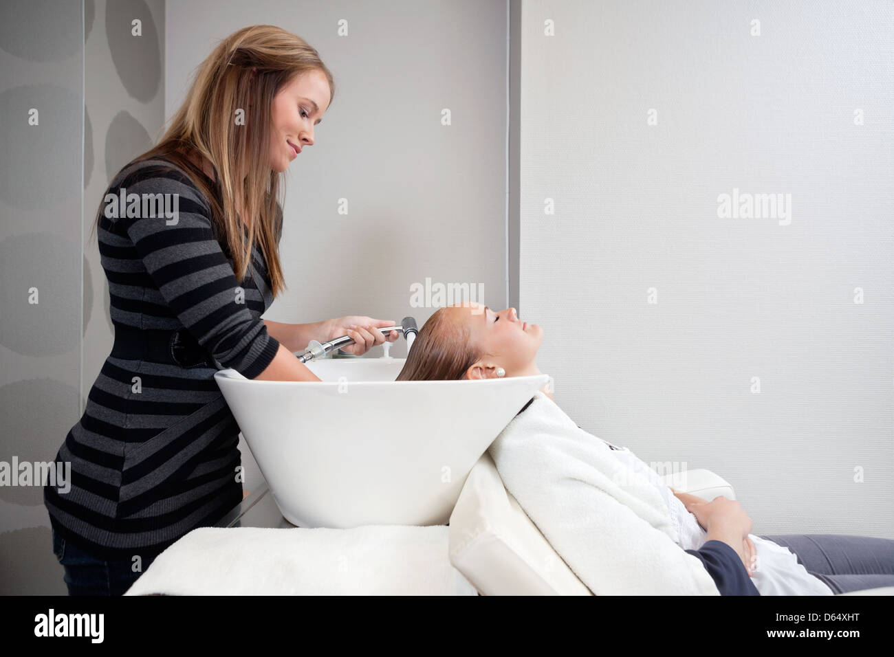 Woman Getting a Hair Wash Stock Photo - Alamy
