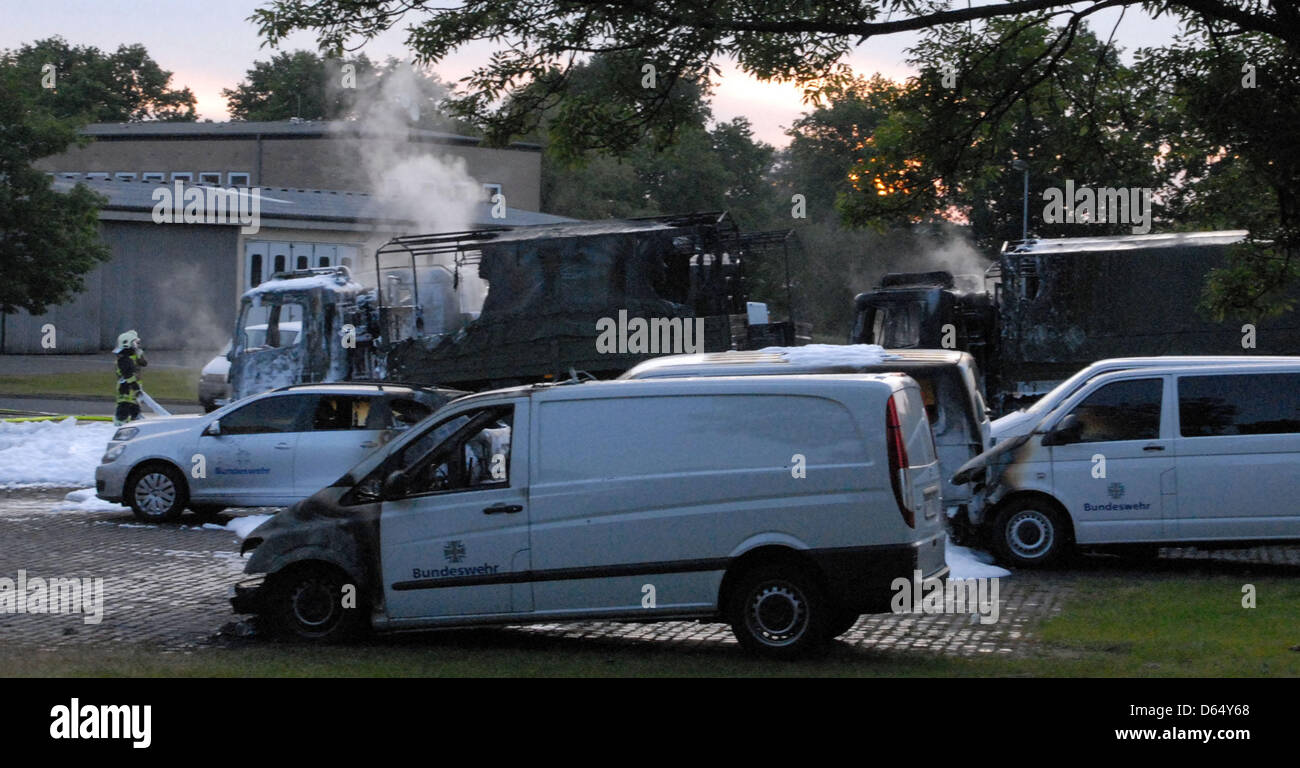 Burned out German Armed Forces (Bundeswehr) vehichles sit on a ...