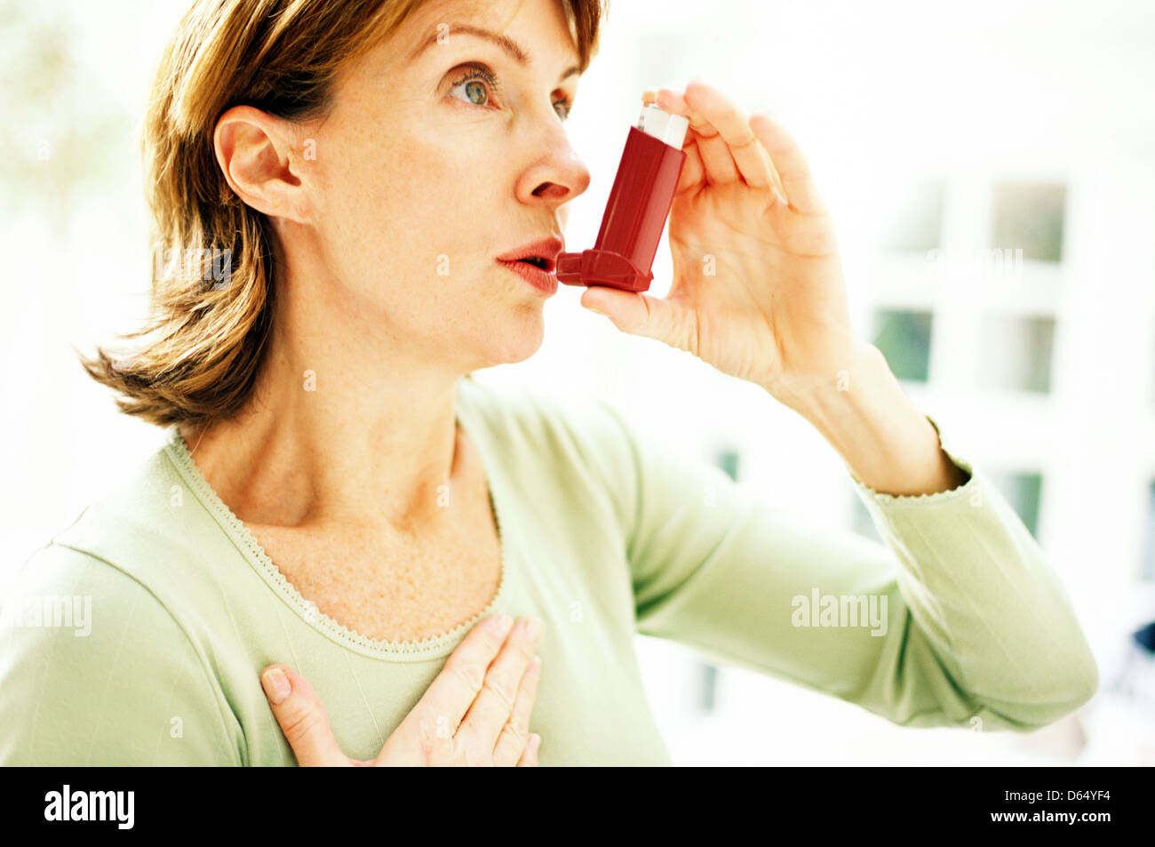 Using asthma inhaler Stock Photo - Alamy
