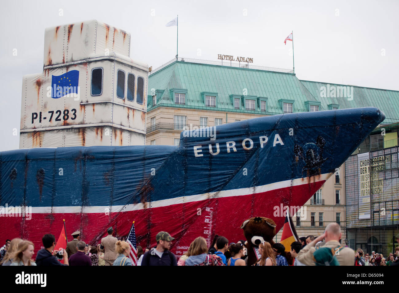 Activists of NGO Greenpeace protest with a recreation of a fishtrawler ...