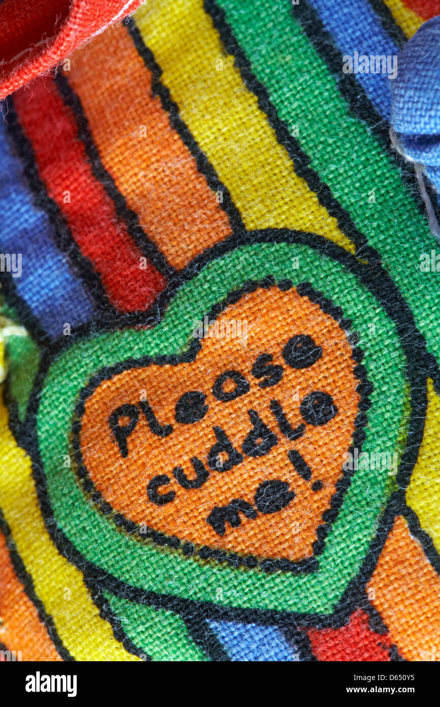 please cuddle me heart on colourful clown toy outfit Stock Photo - Alamy