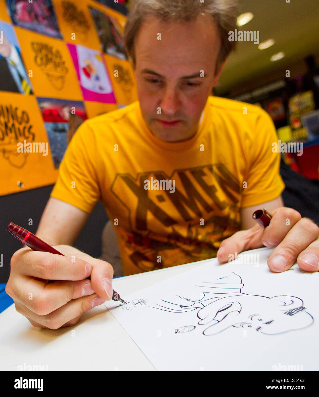 Graphic artist Jo Guhde signs autographs at the comic exposition ...
