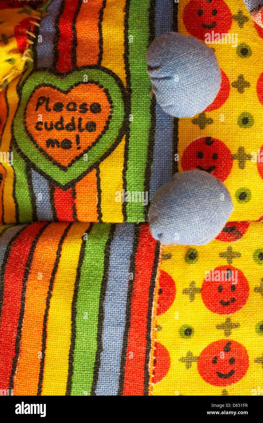 please cuddle me heart on colourful clown toy outfit Stock Photo - Alamy