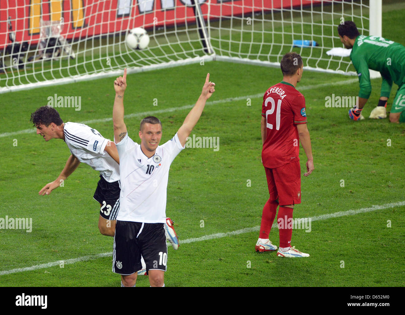 Germany's Lukas Podolski (front) celebrates next to teammate Mario ...