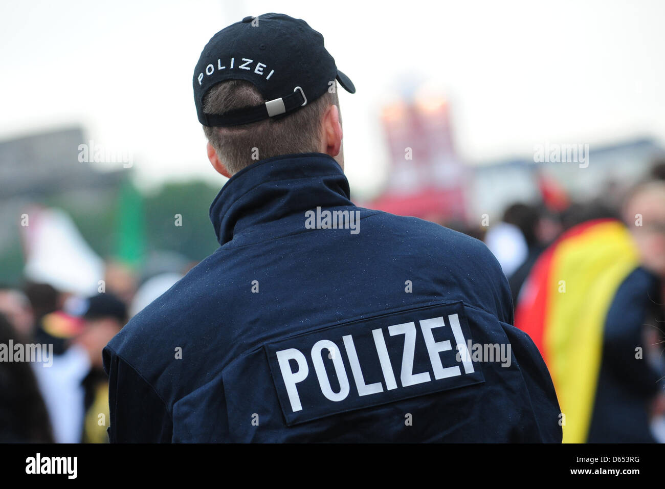 Police officers observe soccer fans following the UEFA EURO 2012 group ...