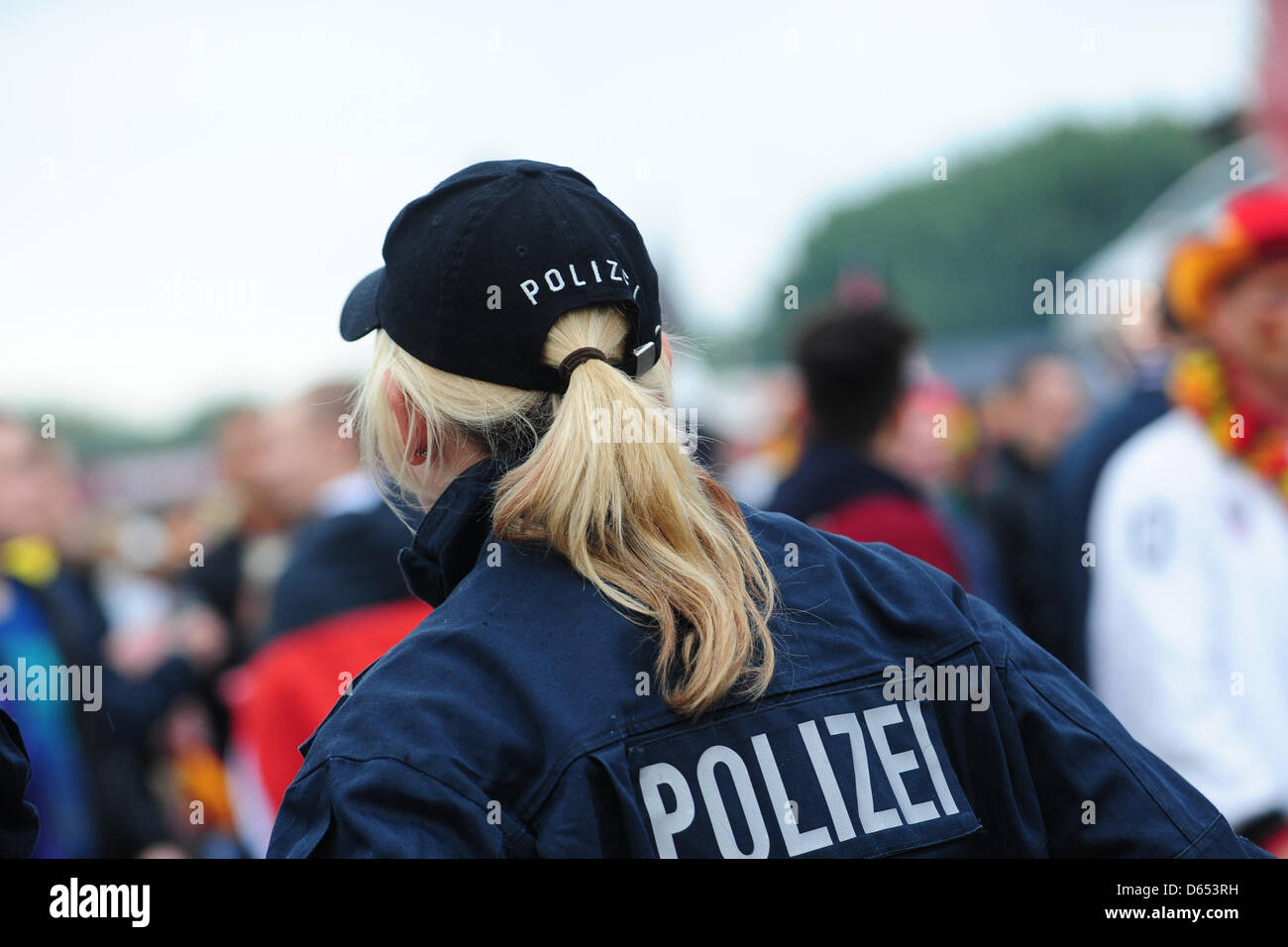 Police officers observe soccer fans following the UEFA EURO 2012 group ...