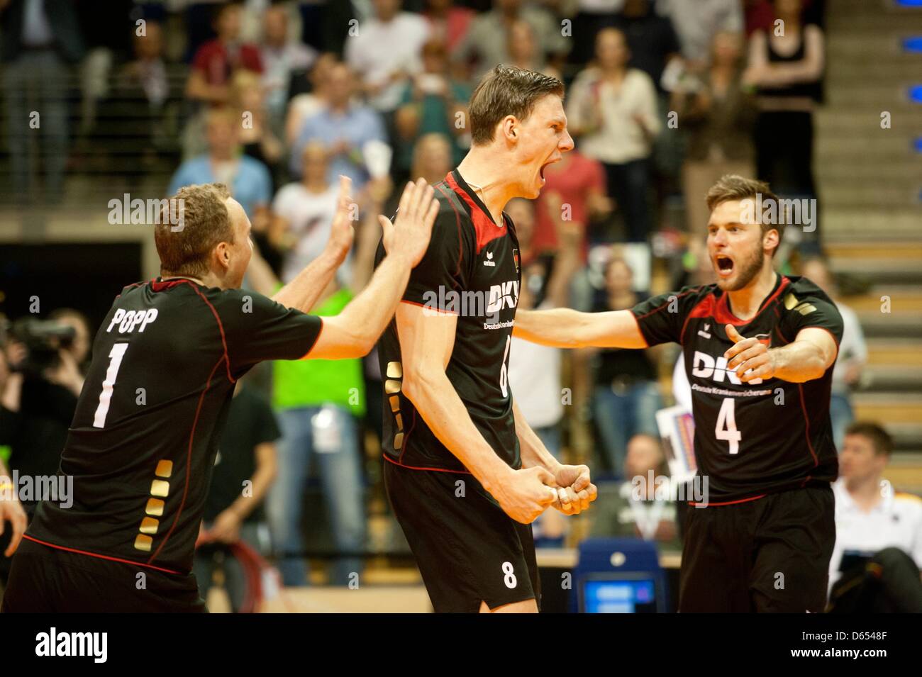 Germany's Marcus Popp (L-R) cheers with Marcus Boehme and Simon Tischer ...