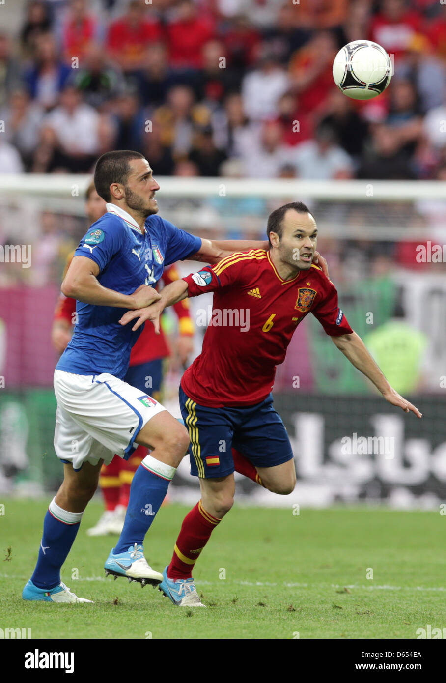 Spain's Andres Iniesta (R) and Italy's Giorgio Chiellini vie for the ...