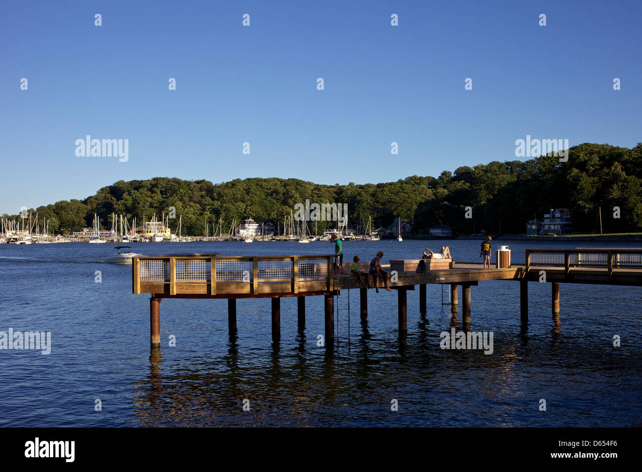People fishing off a pier in Lake Macatawa, Michigan Stock Photo - Alamy