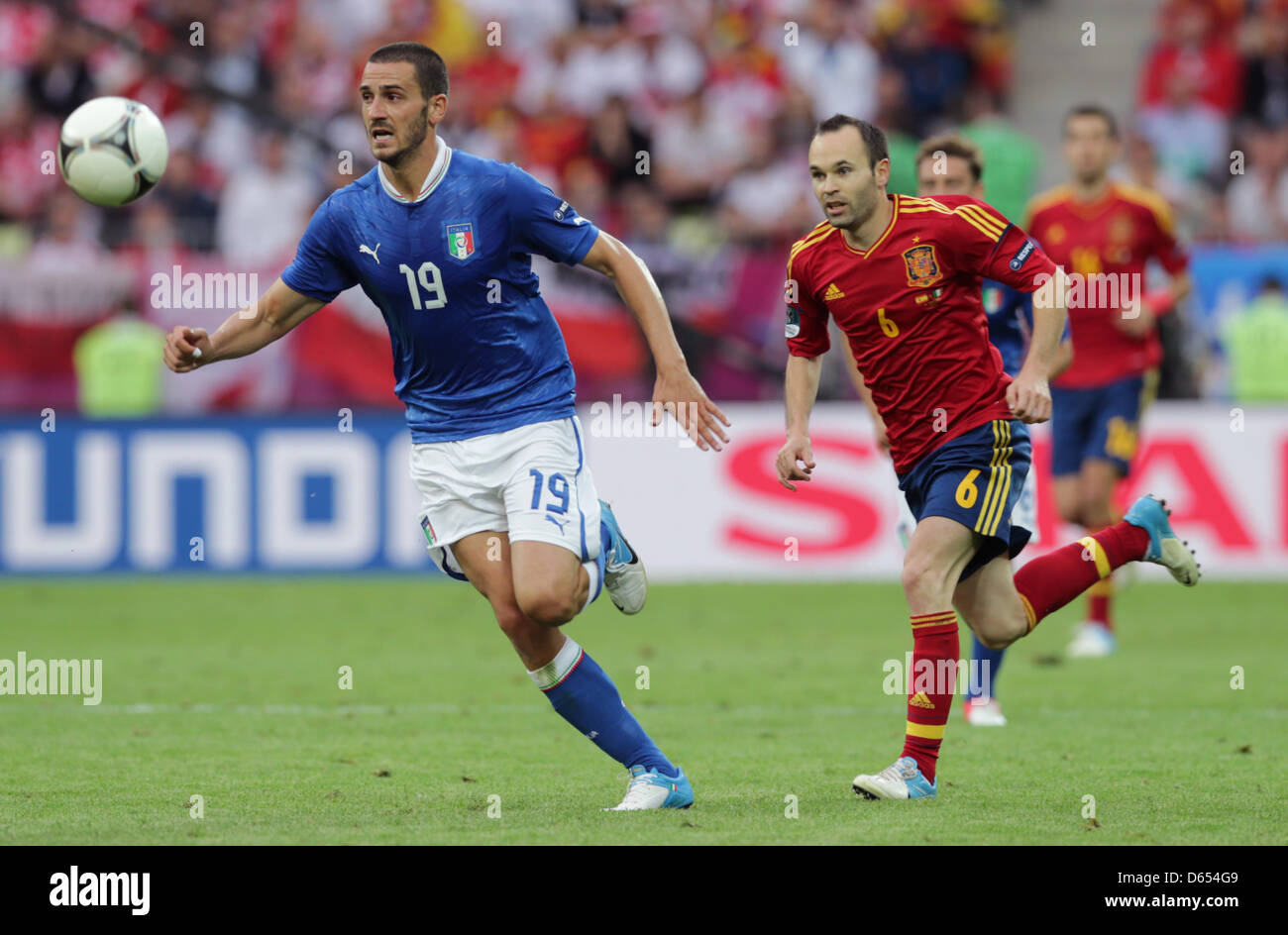 Spain's Andres Iniesta (C) and Italy's Leonardo Bonucci (L) vie for the ...