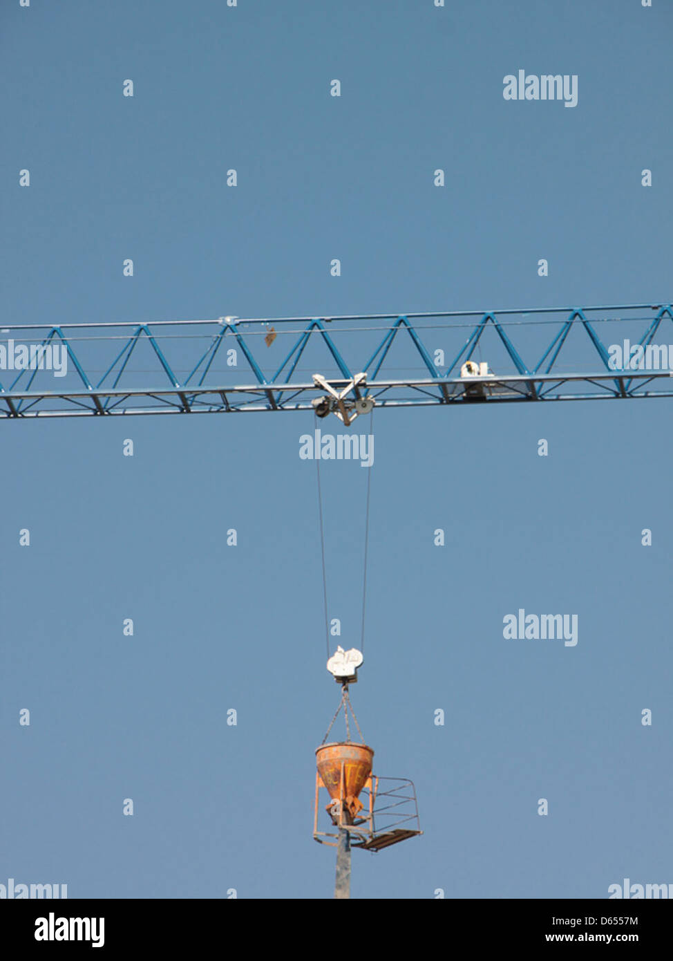 The image shows a crane lifting a heavy concrete container at a ...