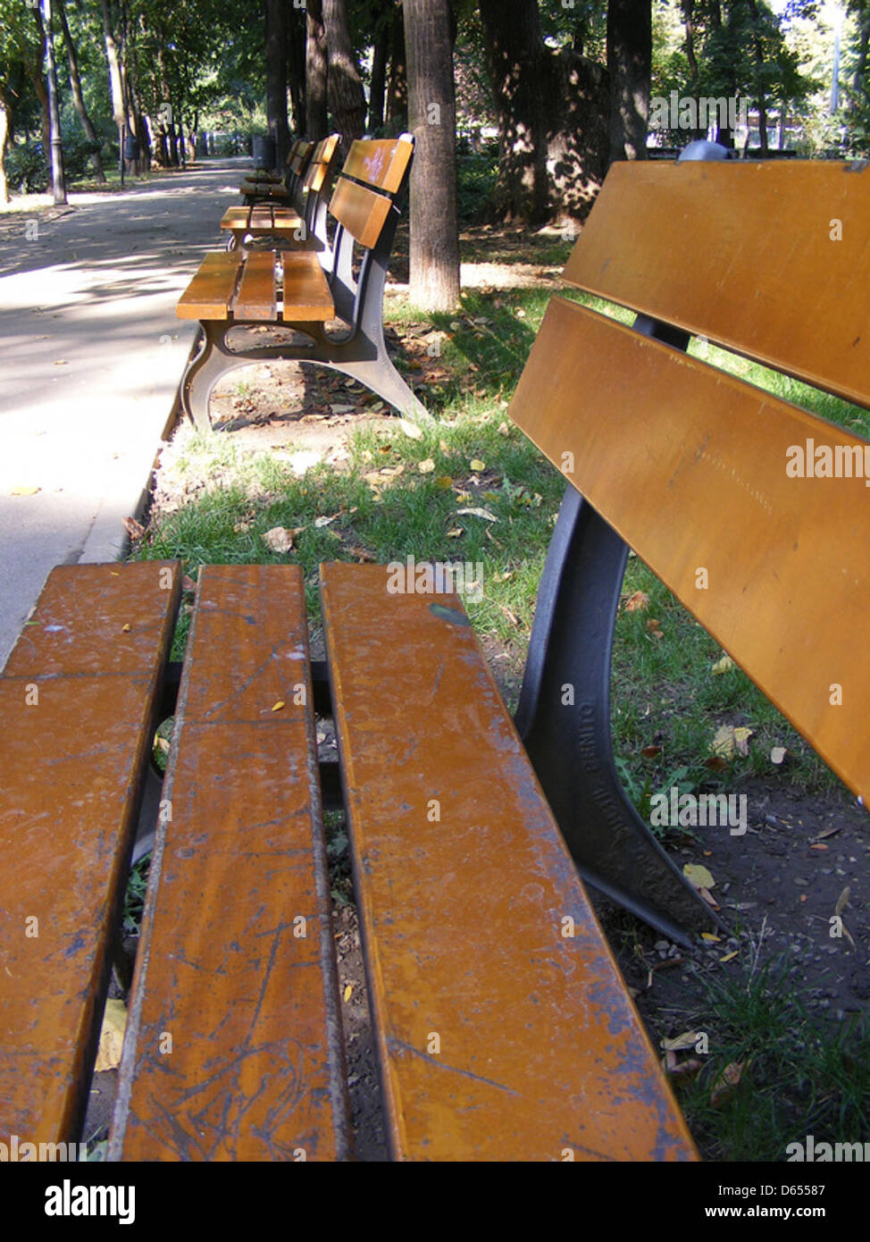 A peaceful end-of-summer scene featuring park benches in a quiet ...