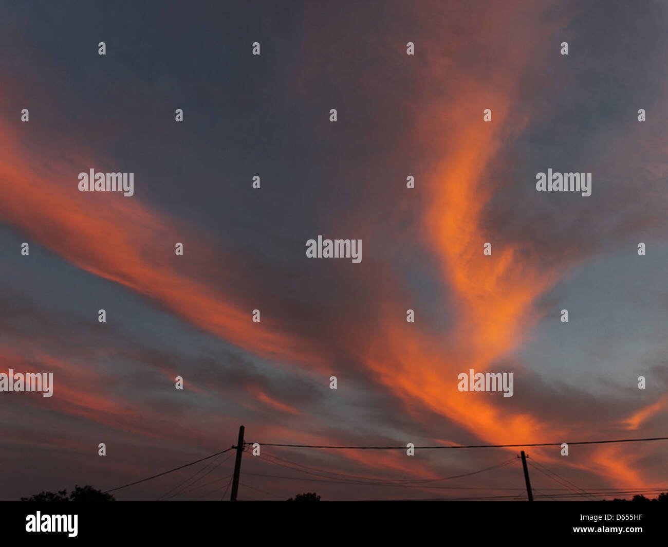 A vibrant sunset scene where the sky is painted with multiple colours ...