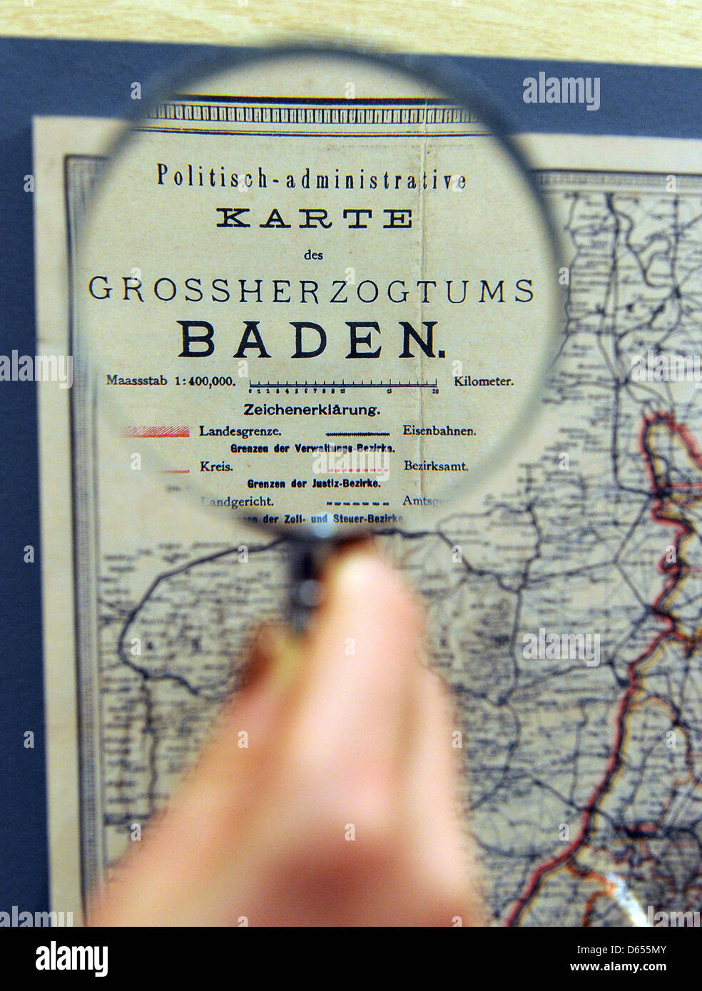 A visitors of the Baden State Museum observes a map of Grand Duchy of ...