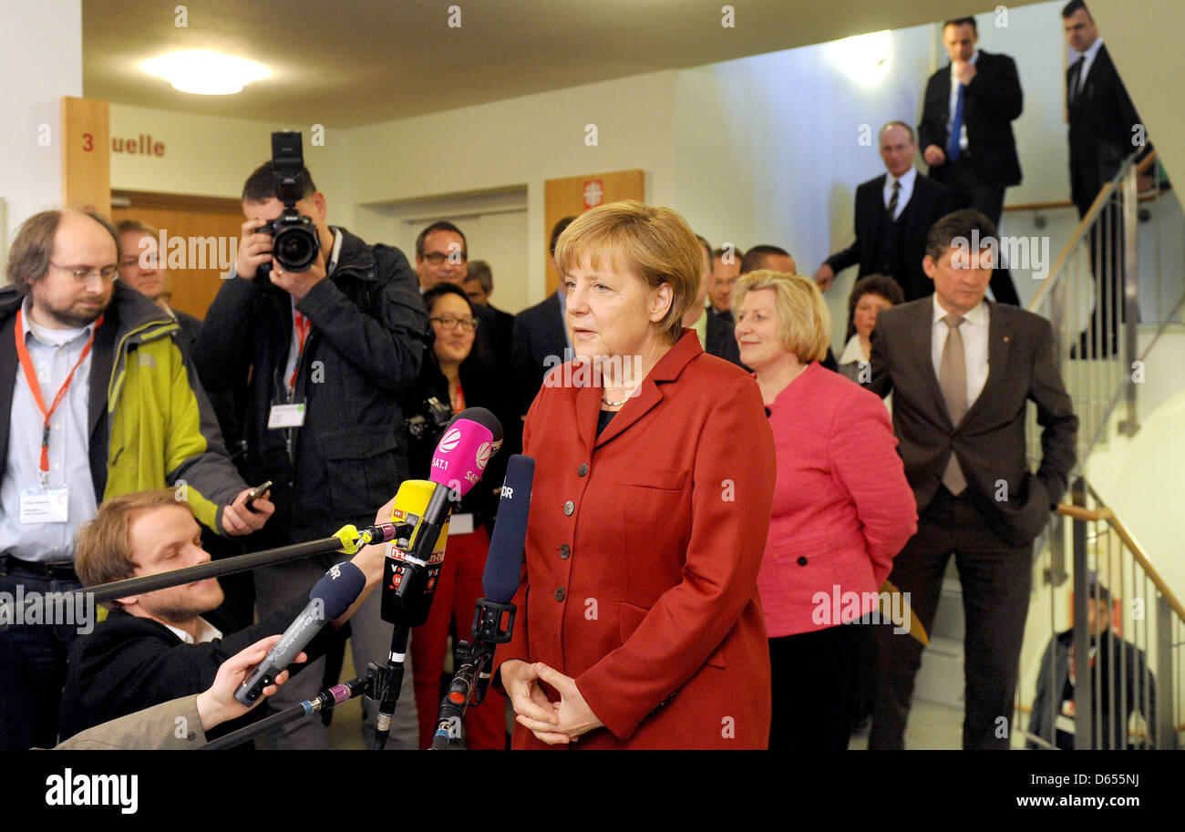 German Chancellor Angela Merkel (C) gives an interview during her visit ...