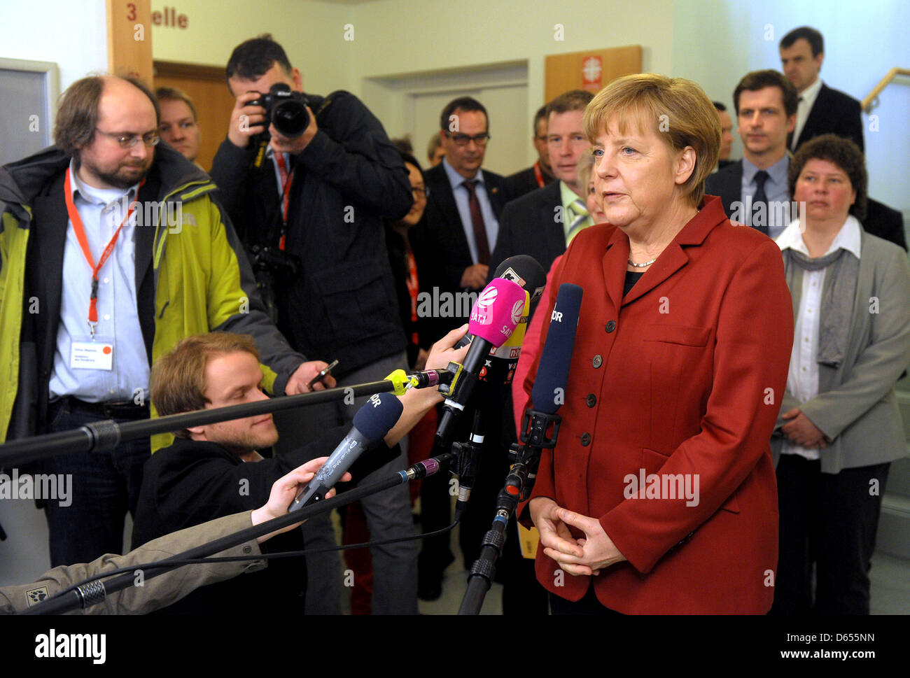 German Chancellor Angela Merkel (2-R) gives an interview during her ...