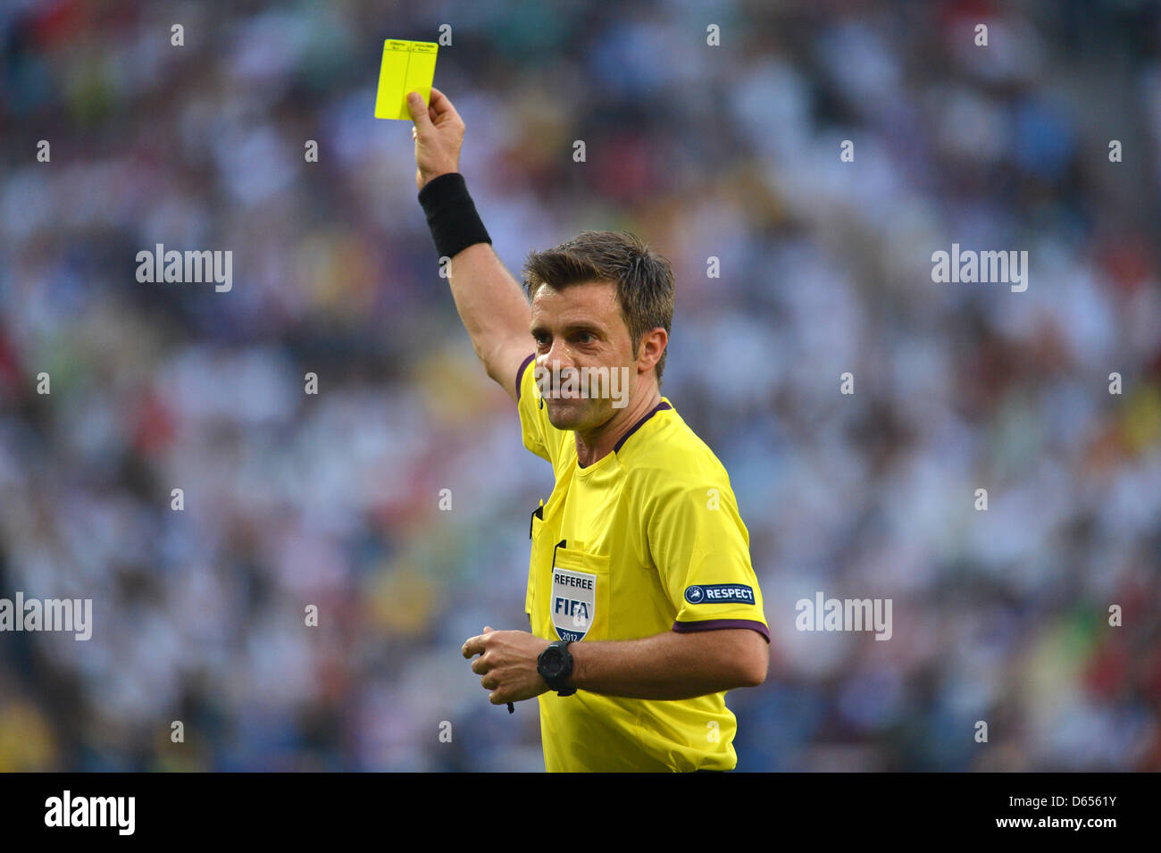 Italian referee Nicola Rizzoli holds the yellow card during the UEFA ...