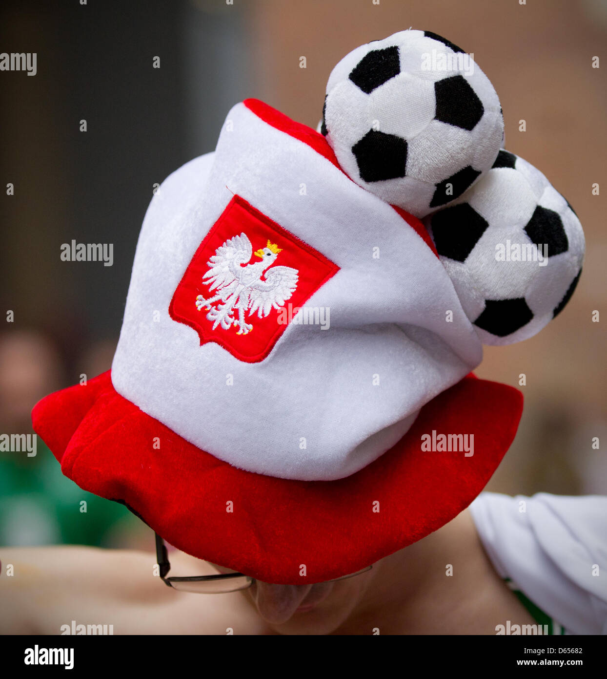 A Polish fan presents his football hat in the city center of Gdansk ...