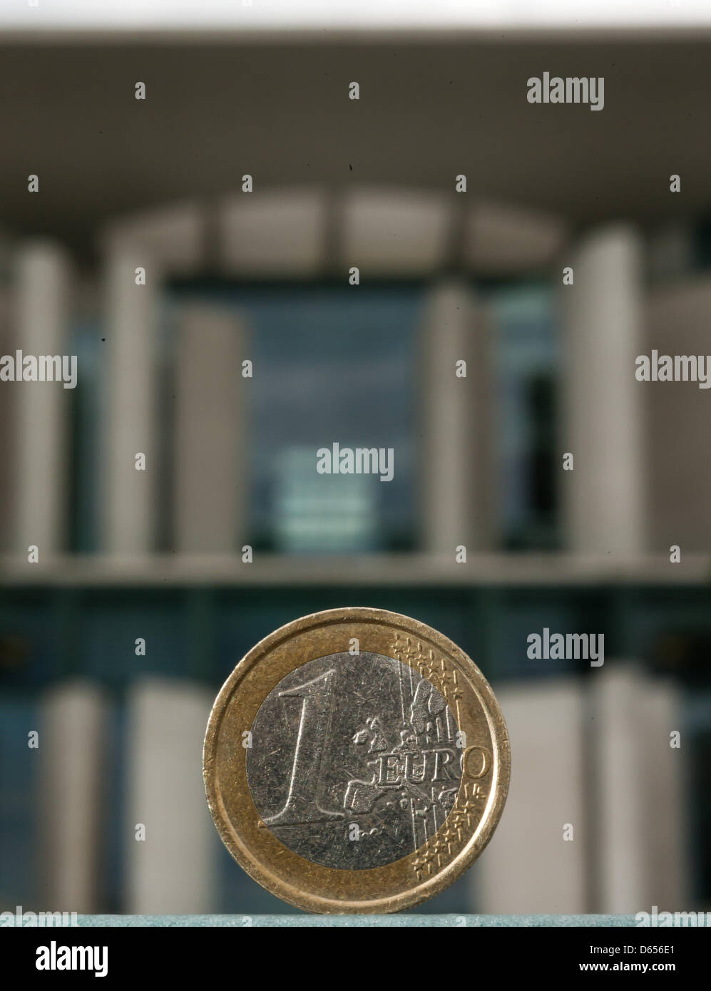 The illustration shows a one-euro coin and a two-euro coin positioned ...