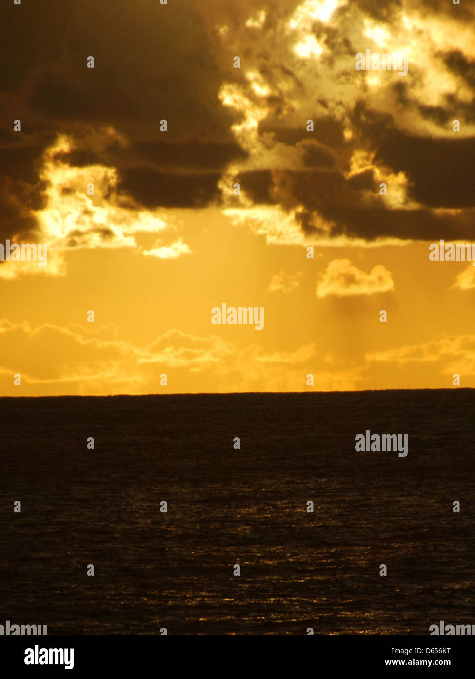 The photograph captures a stunning sunset over the Atlantic Ocean, with ...