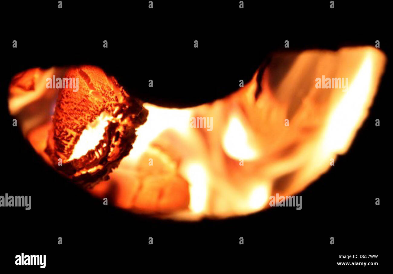 This image depicts fire burning inside a boiler used for central ...