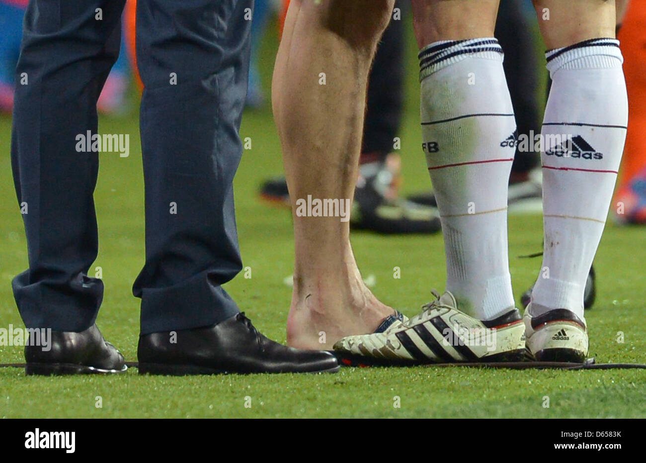 The feet of Germany's head coach Joachim Loew, the Netherlands' Mark ...