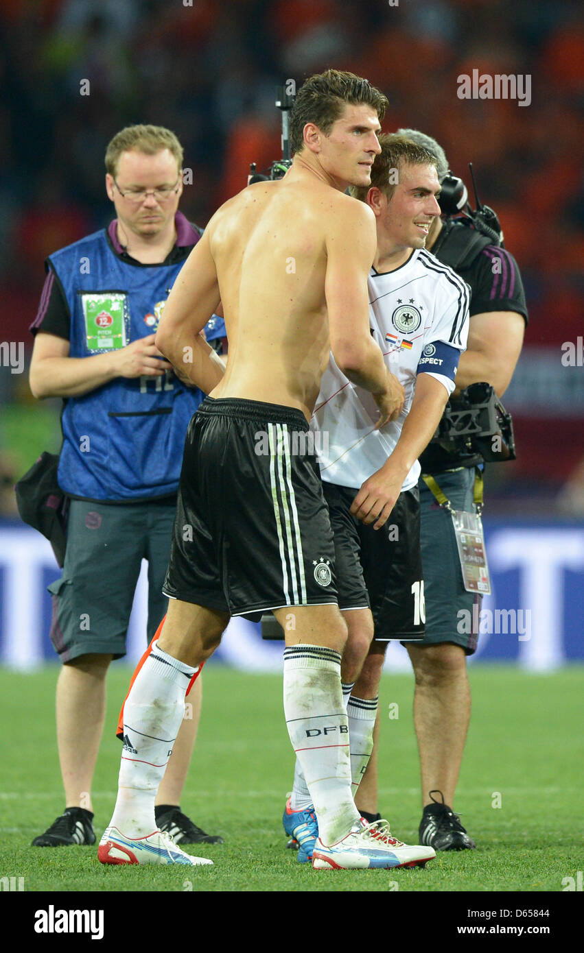 Germany's Philipp Lahm (R) and Mario Gomez hug after during the UEFA ...