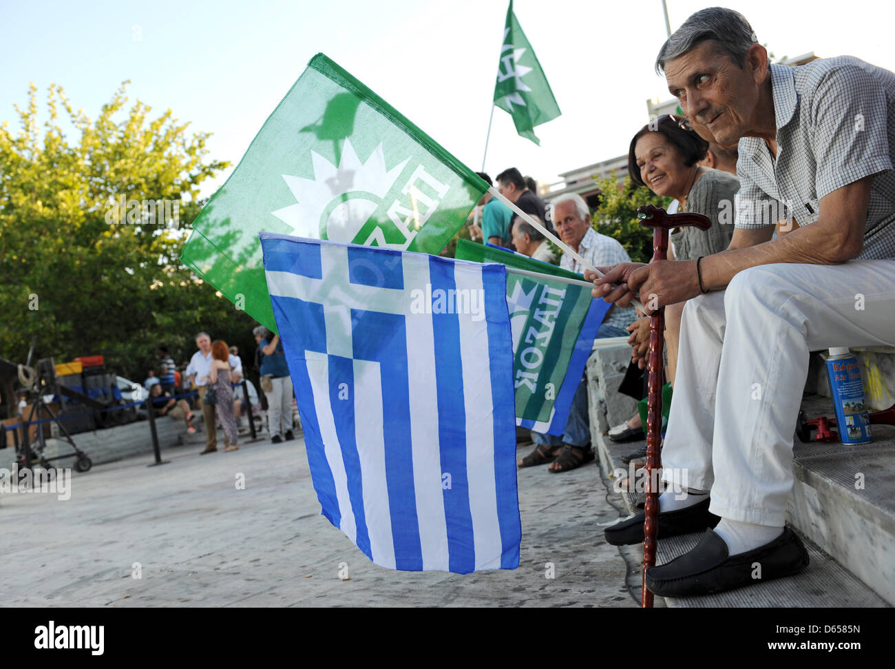 Supporters hold Greek and PASOK party flags before an election campaign ...