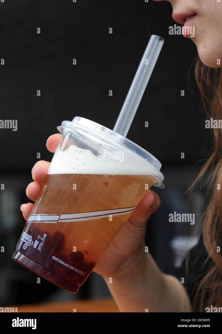 A young woman drinks bubble tea at a McCafe in Berlin, Germany, 12 June ...