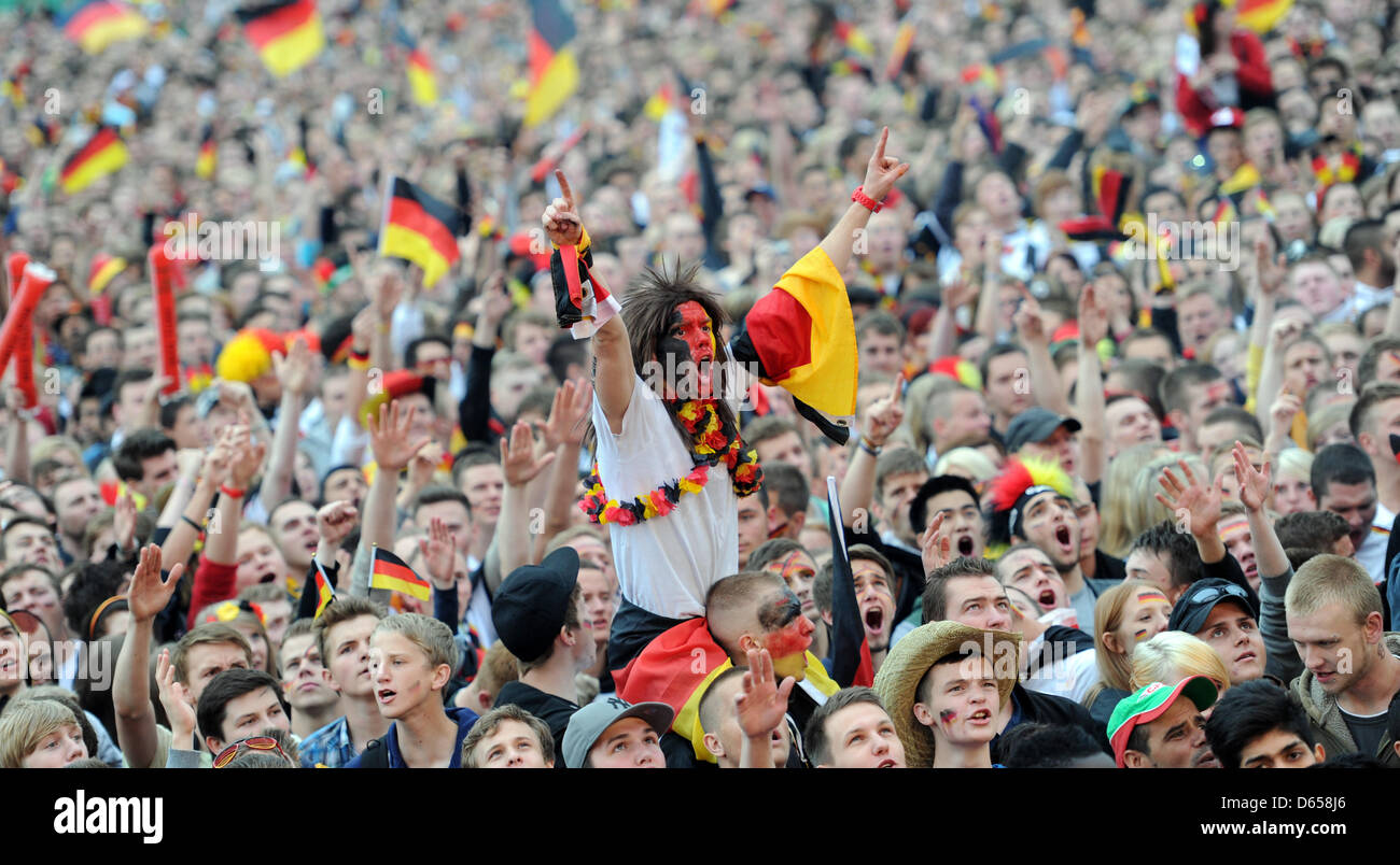 Two fans of the German soccer team cheer during a public screening of ...