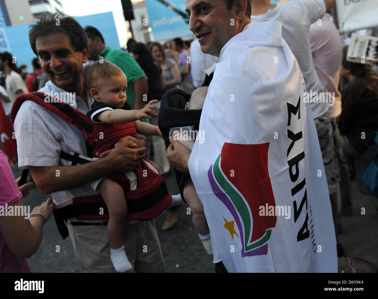 Supporters of the Greek SYRIZA party attend an election campaign event ...