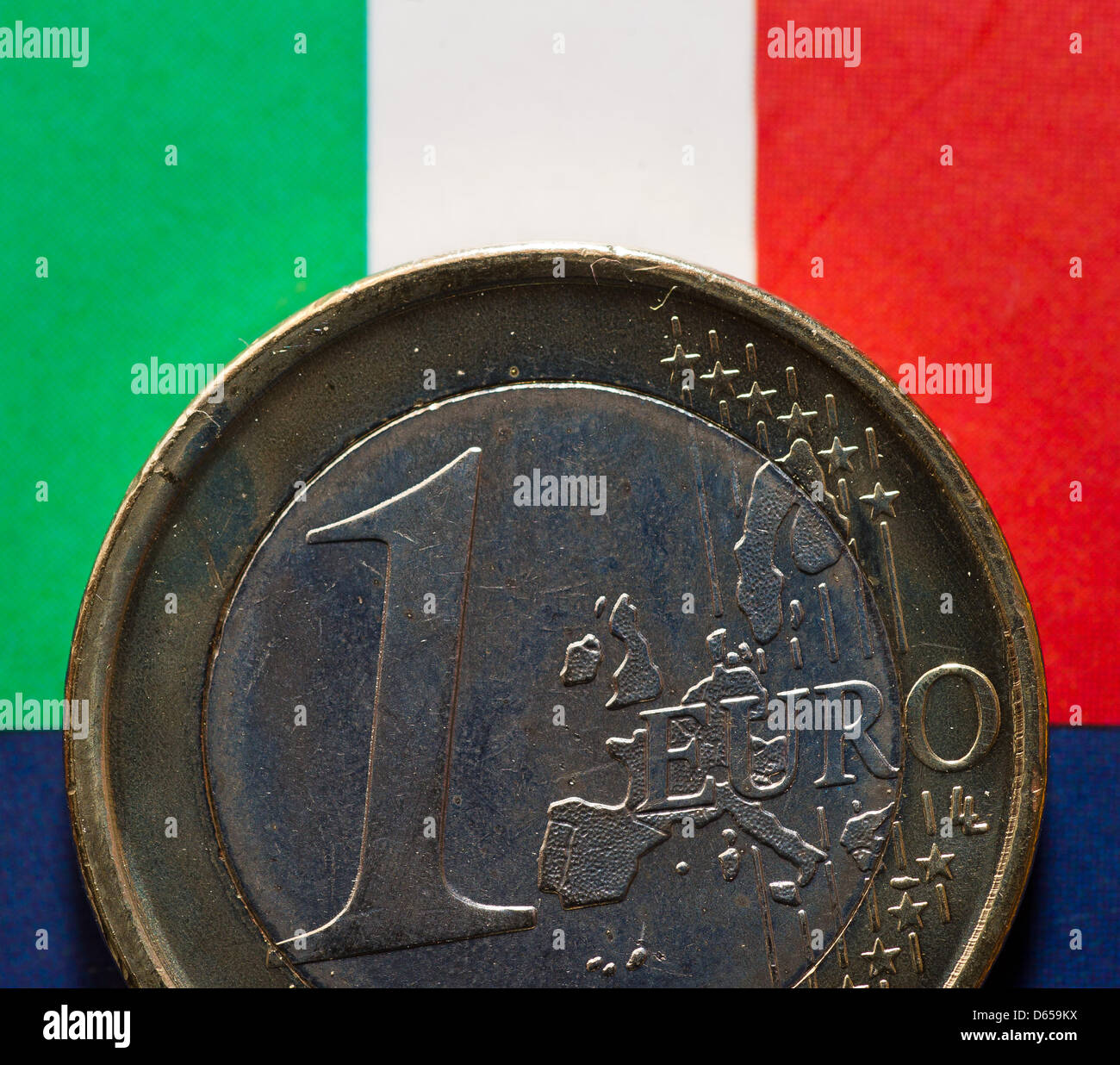 A one Euro coin is pictured next to an Italian flag in Frankfurt ...