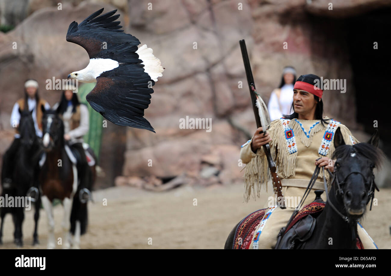 An African Fish Eagle flies past actor Erol Sander as Winnetou (C ...