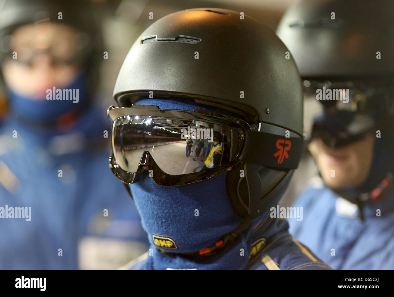 The pit lane reflects in the goggles of a Team Felbermayr-Proton ...