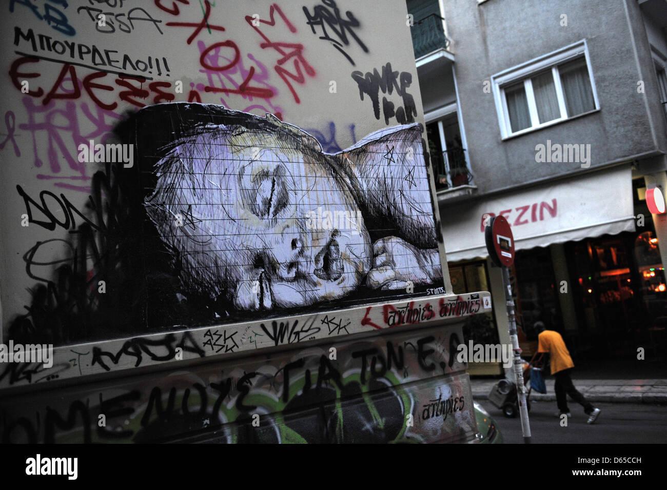 The graffiti of a sleeping child covers the side of a house in Athens ...