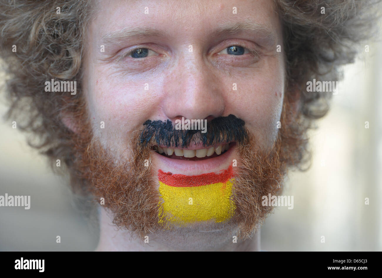 A supporter of Germany smiles before UEFA EURO 2012 group B soccer ...