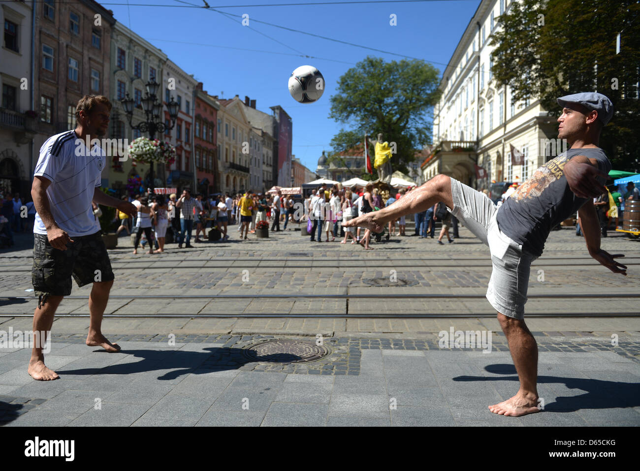 Two men play football before UEFA EURO 2012 group B soccer match ...