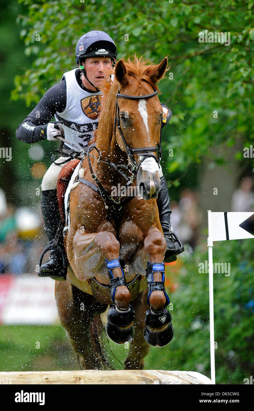 English rider Oliver Townend jumps his horse Armada over a water ...
