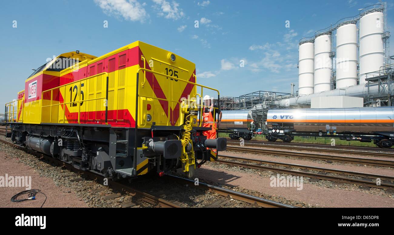 A worker examines a locomotive with a hybrid engine at a compound of ...