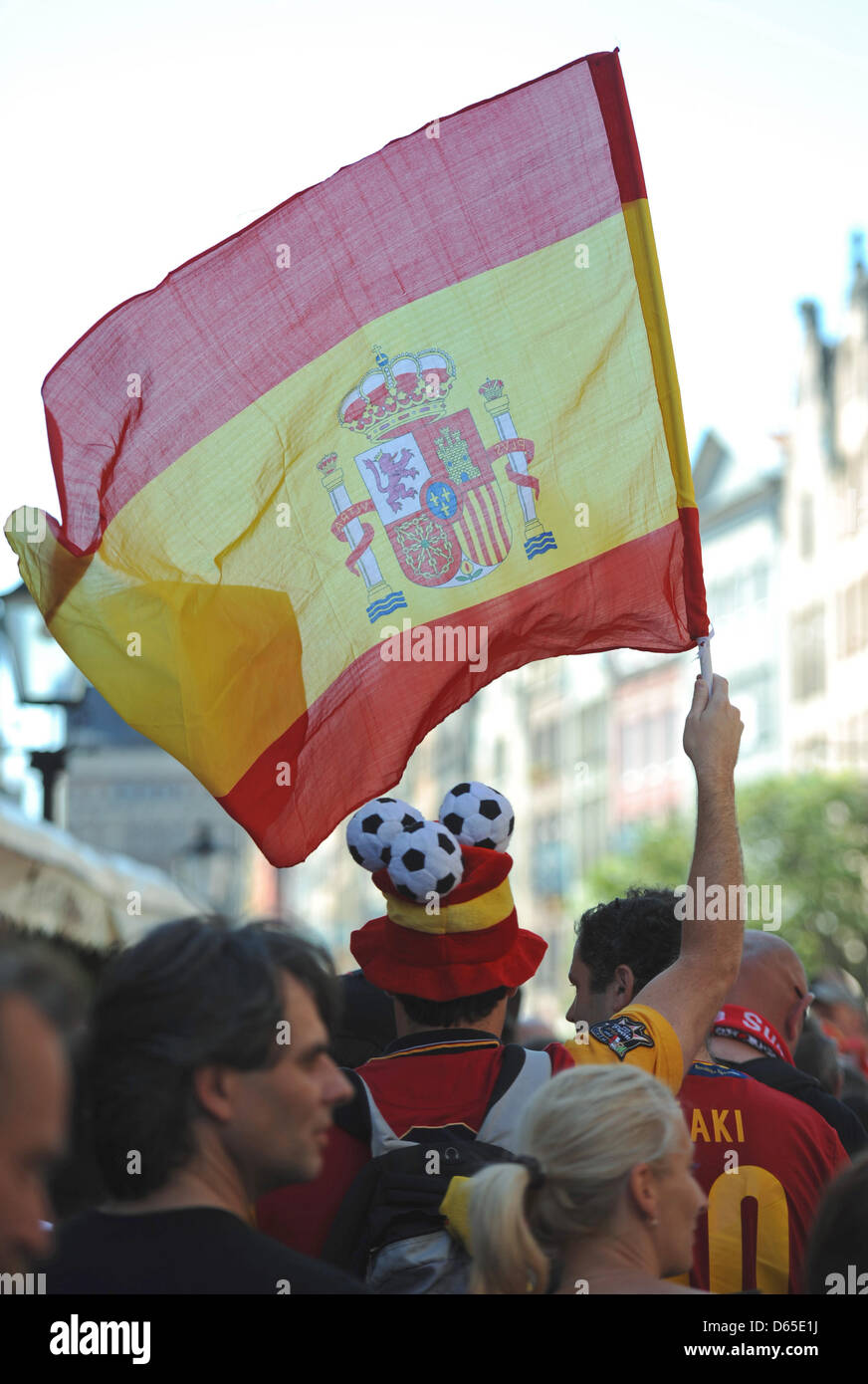 A Spanish football supporter carries a Spanish flag through the city ...