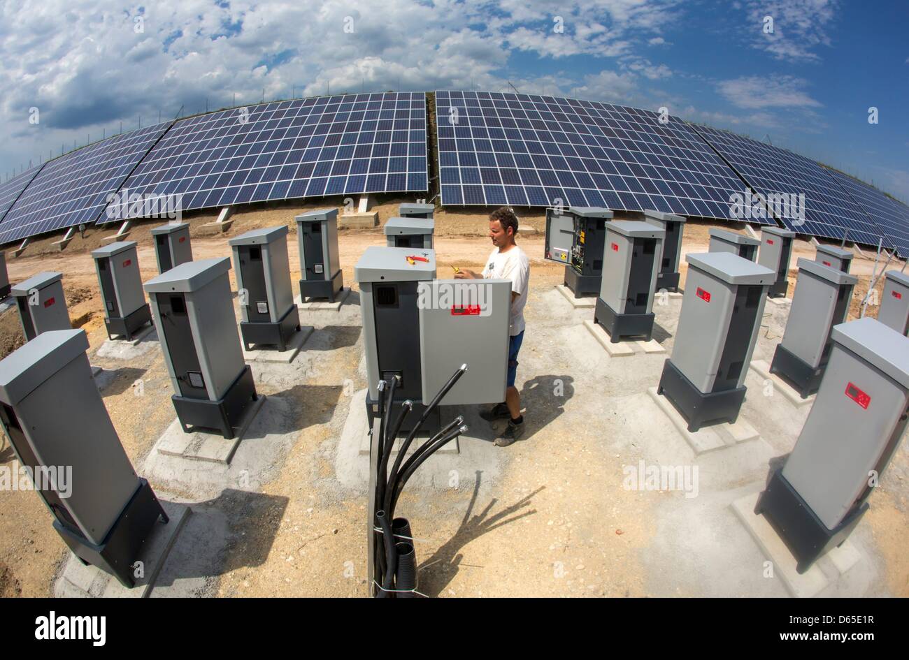An electrician checks the incoming potential of a solar table of the ...