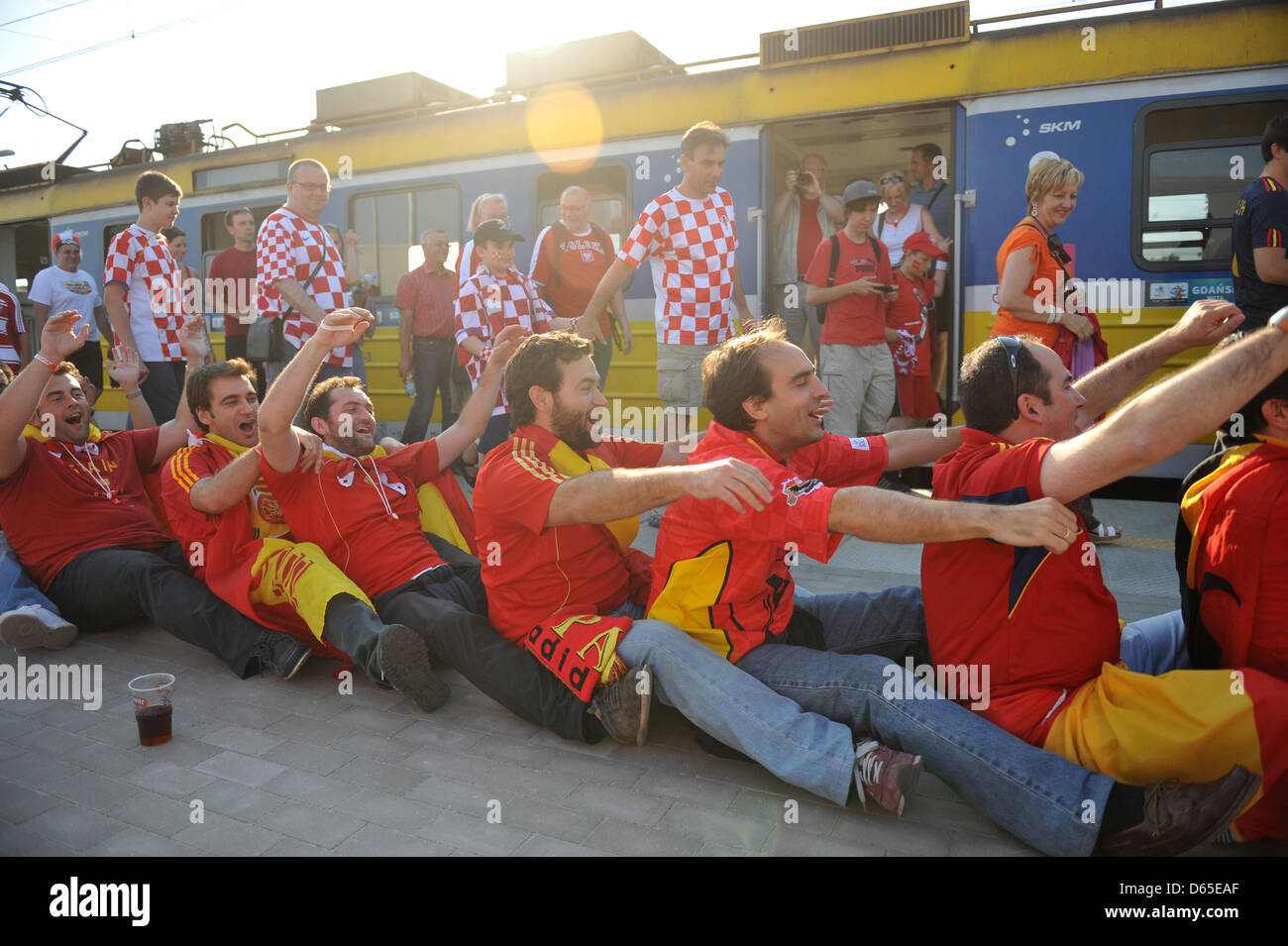 Spanish football fans celebrate at the train station in front of the ...