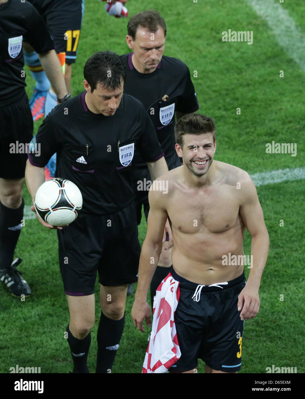 Spain's Gerard Pique (R) and referee Wolfgang Stark (L) of Germany ...