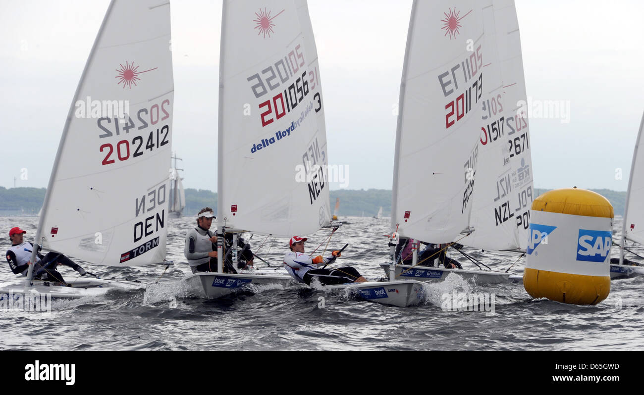 Sailors with Laser class boats take part in a "Medal Race" during Kiel ...