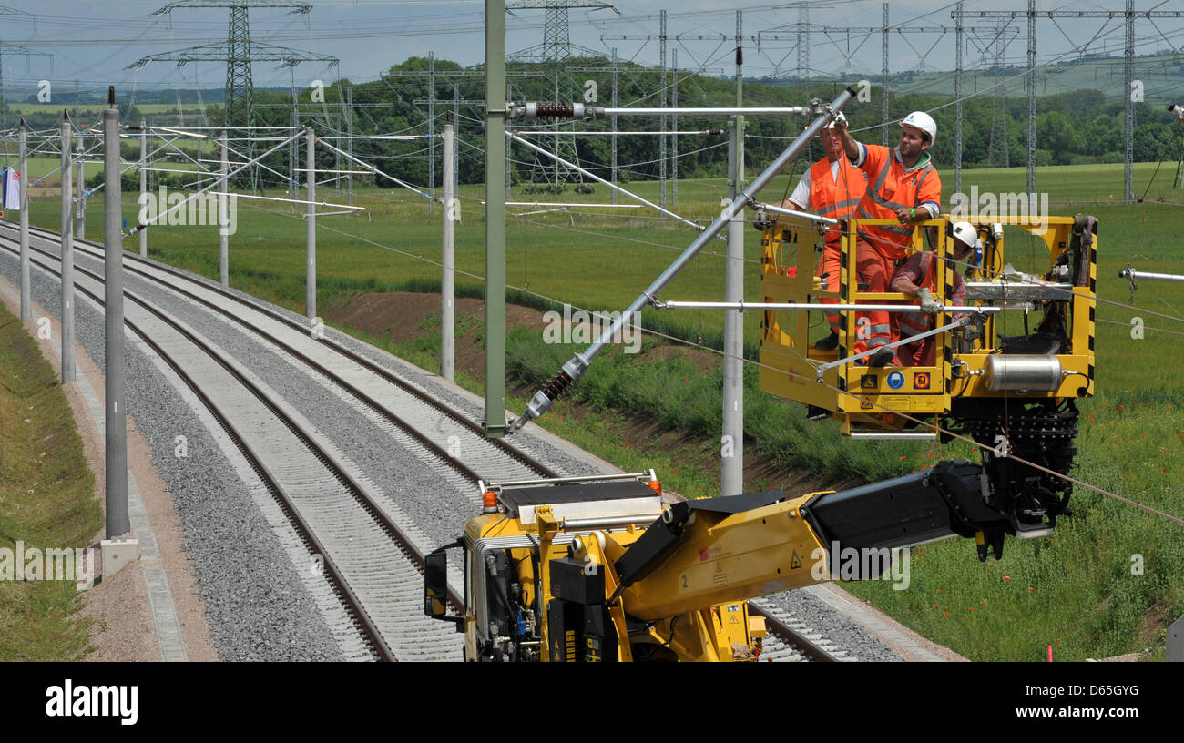 Workers install overhead wiring for the future ICE highspeed line ...