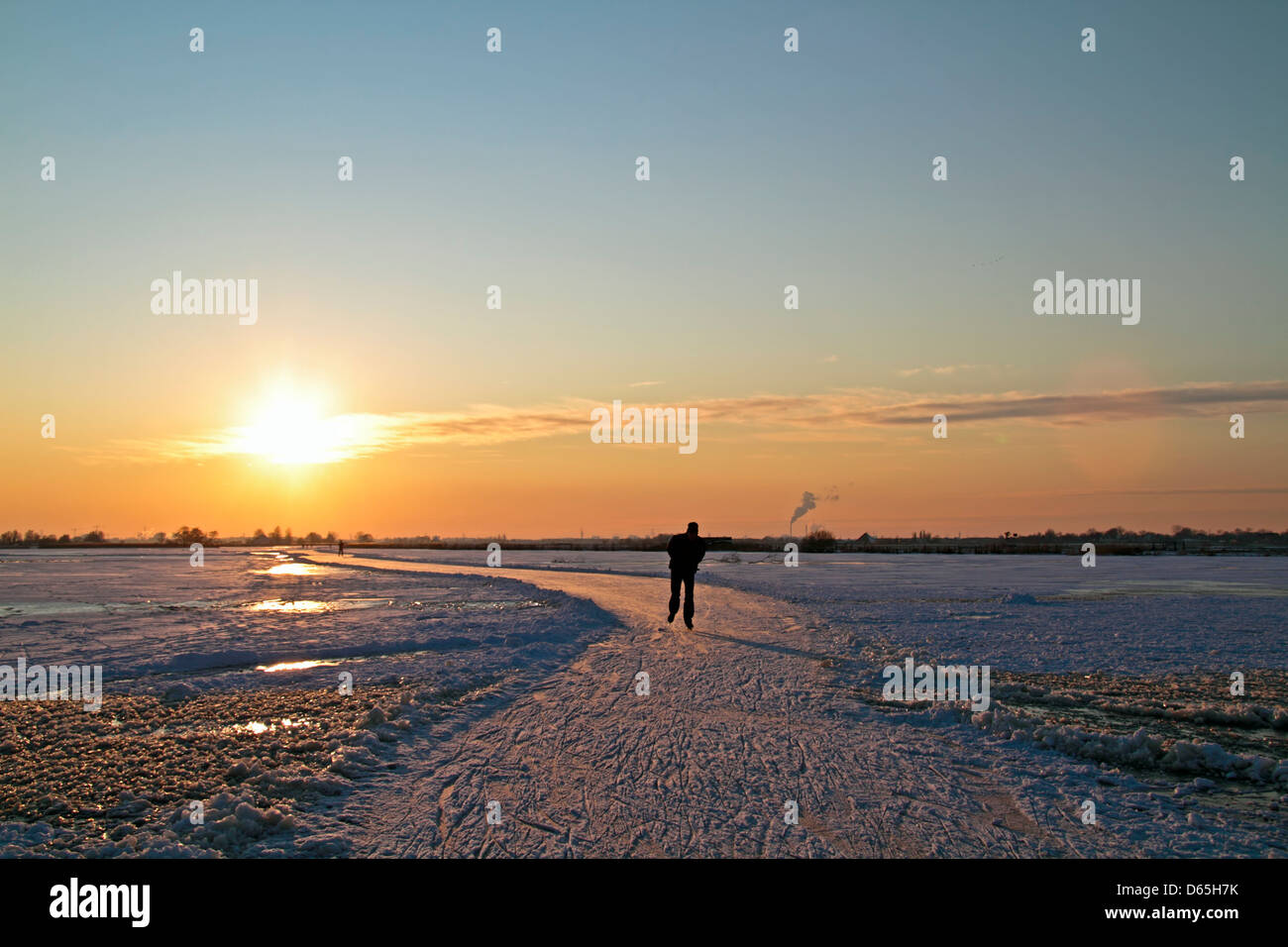 Ice skating in the countryside from the Netherlands at sunset Stock ...